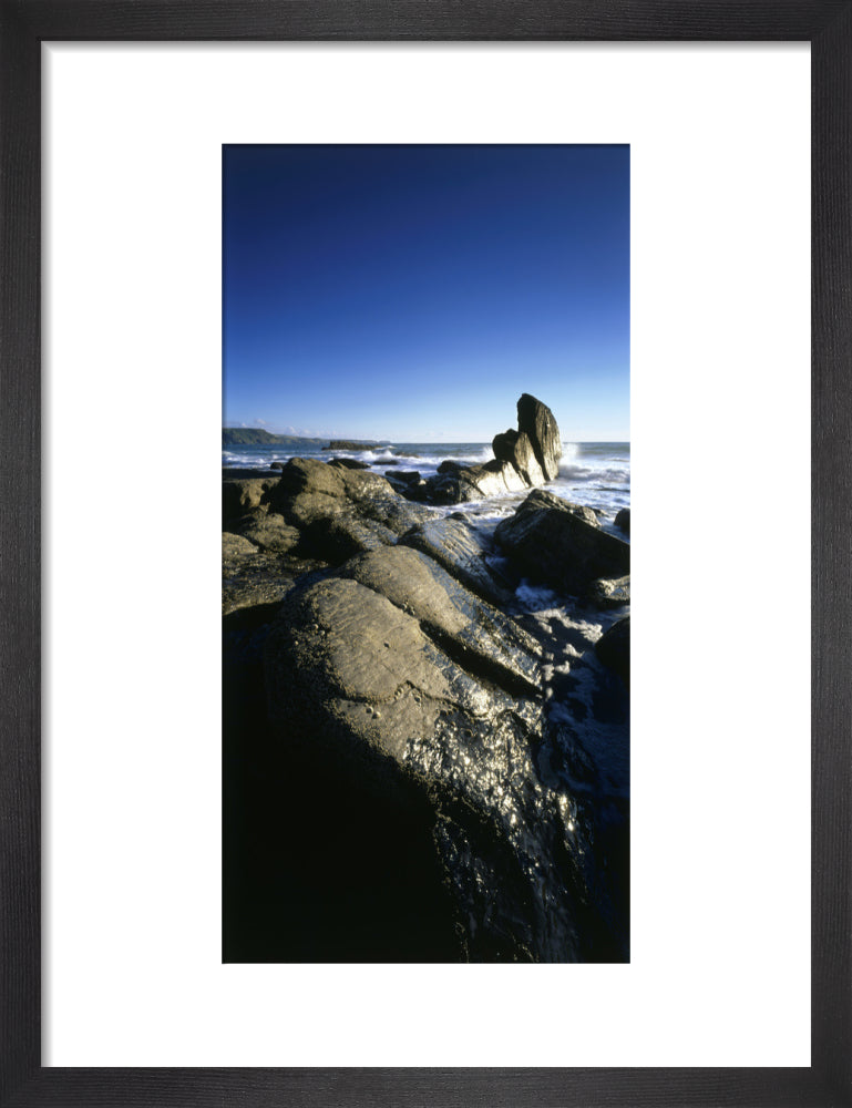 A close view of folded and eroded granite rock strata at Little Strand ...