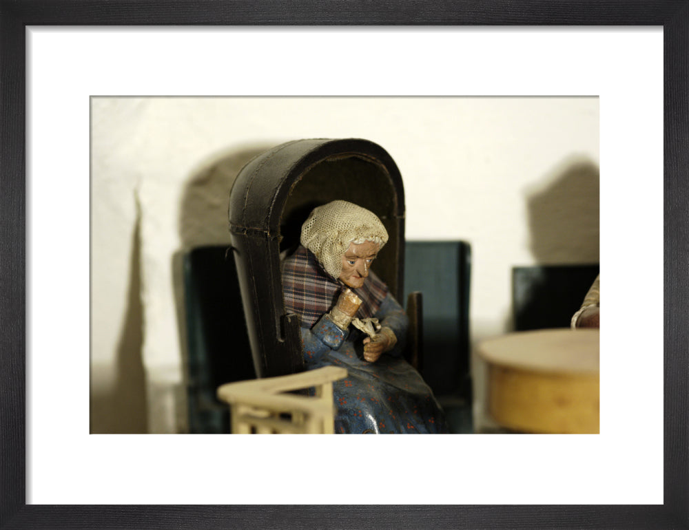 Close view of one of the figures of an old lady, one of a pair, which ...