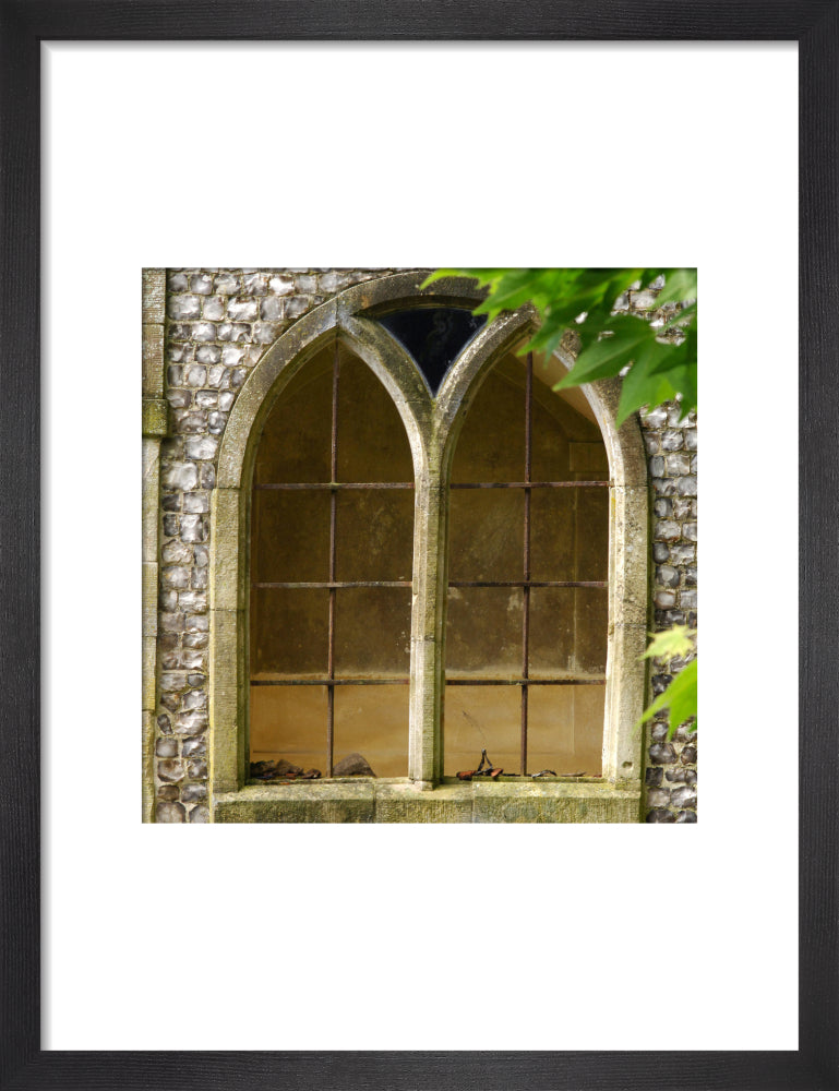 A double arched window with stone mullions, set into a flint wall at M ...