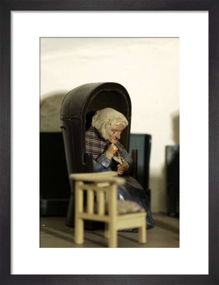 Close view of one of the figures of an old lady, one of a pair, which ...