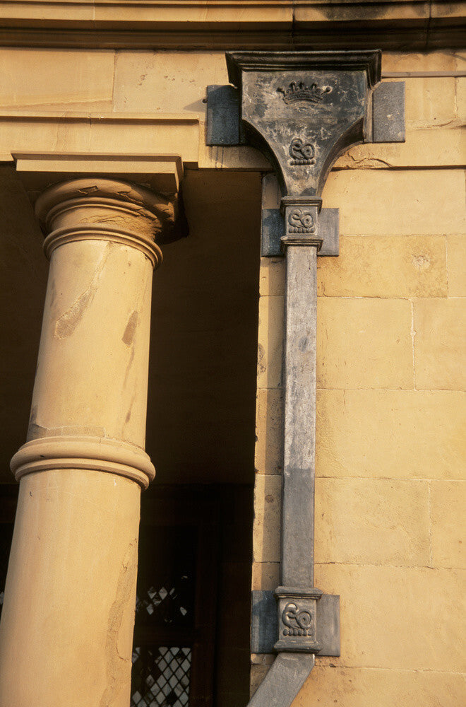 Close-up of a rain water down pipe and the top of a pillar, at Hardwic ...