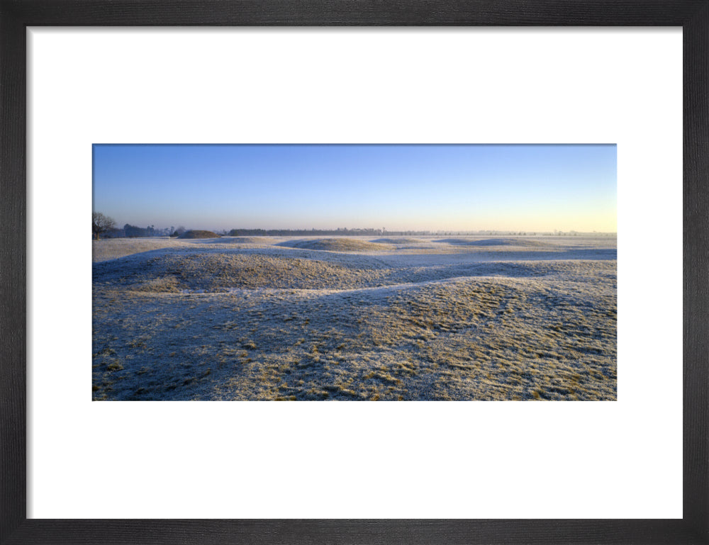A view across the frost covered burial mounds at Sutton Hoo on a frost ...