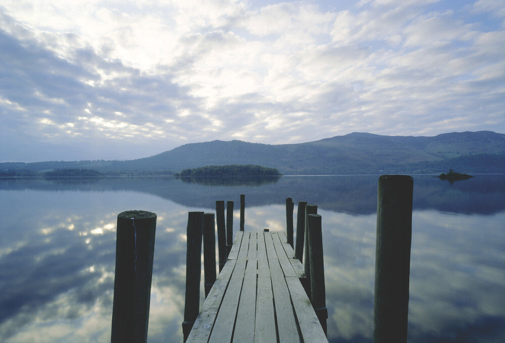 A landing stage at Hawse End with Castlerigg Fell on the far side of t ...