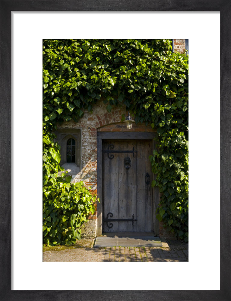 The wooden entrance door in the Courtyard at Baddesley Clinton, Warwic ...